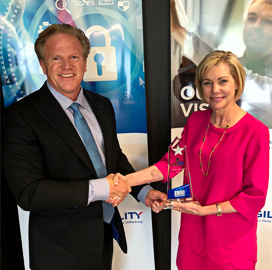 Jim Garrettson Presents Lynn Dugle With Wash100 Award - GovCon Wire